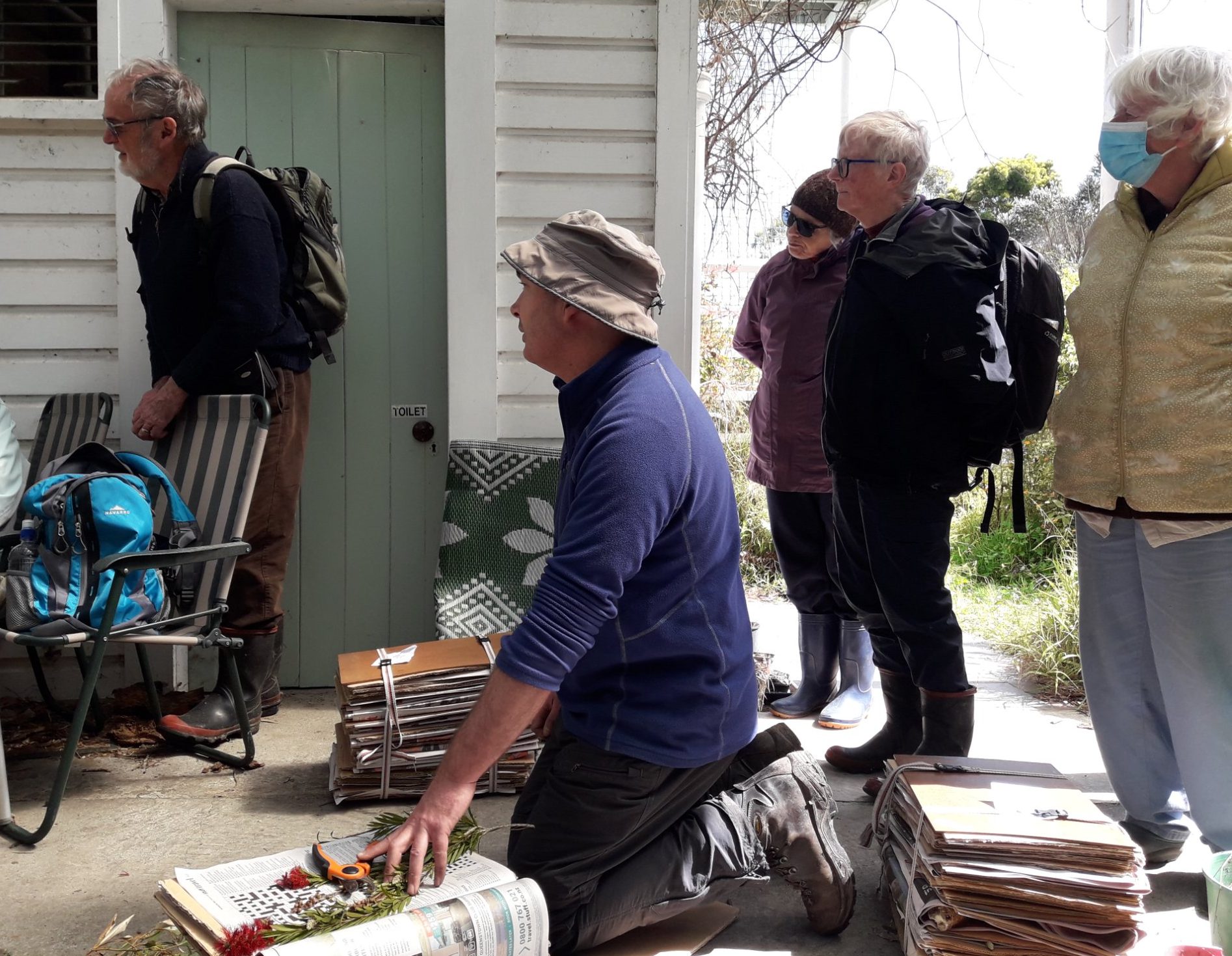 Leon demonstrates pressing a specimen to the Whanganui Botanical Group ...